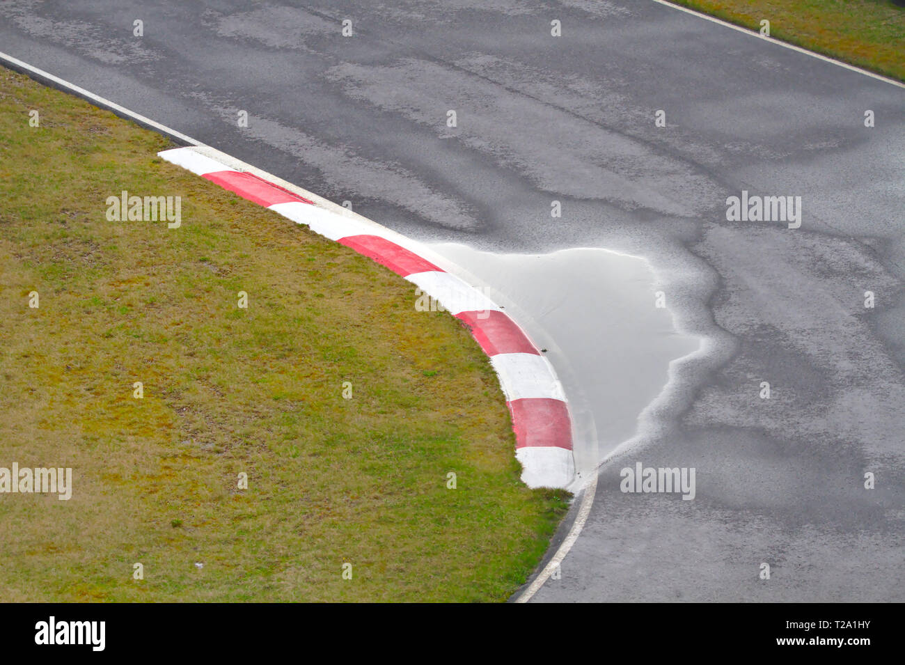 Wet right curve on a race track Stock Photo - Alamy
