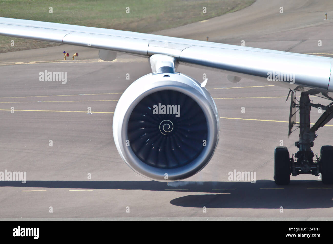 Closeup of right wing and a jet engine of a white commercial airplane ...