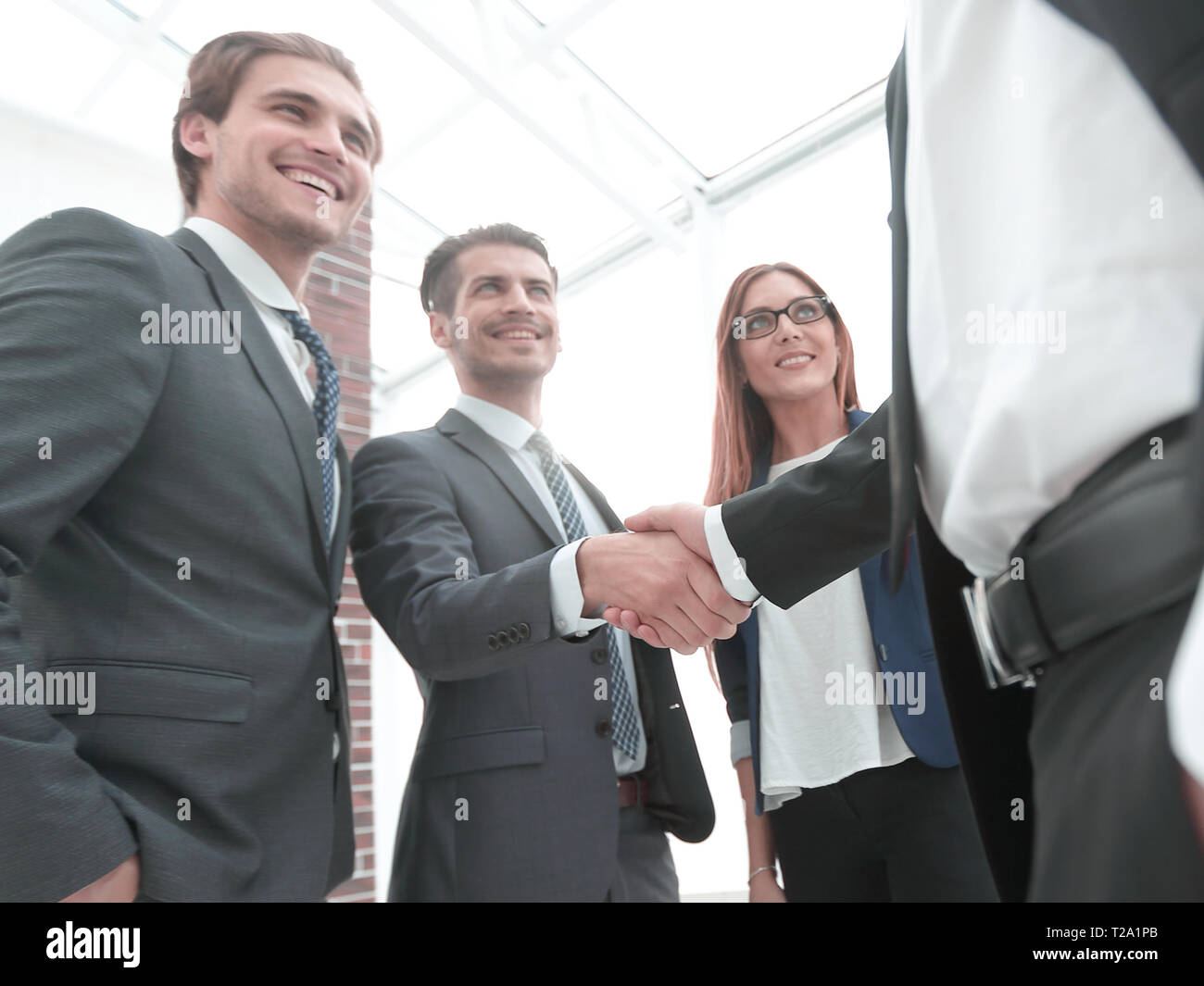 Business shaking hands in the office Stock Photo - Alamy