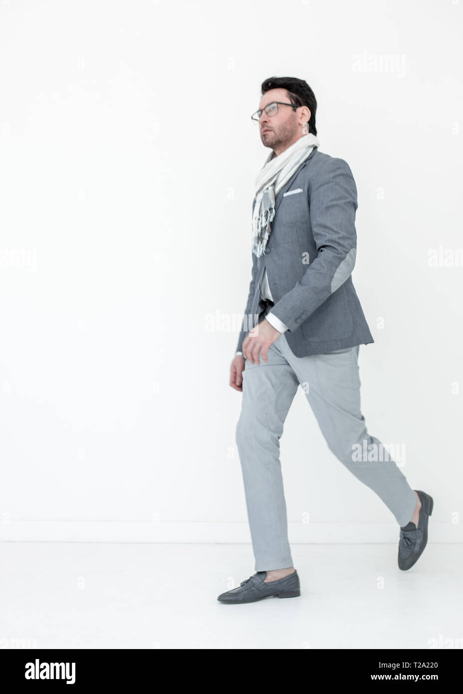 side view .a serious man confidently striding forward Stock Photo - Alamy