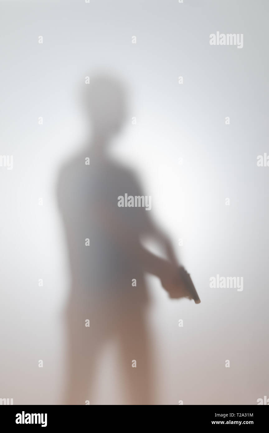 blurred silhouette of a man with a gun Stock Photo - Alamy