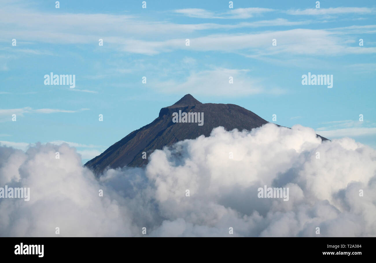 Peak of Volcano Mount Pico over the clouds , Pico Island - Azores Stock ...