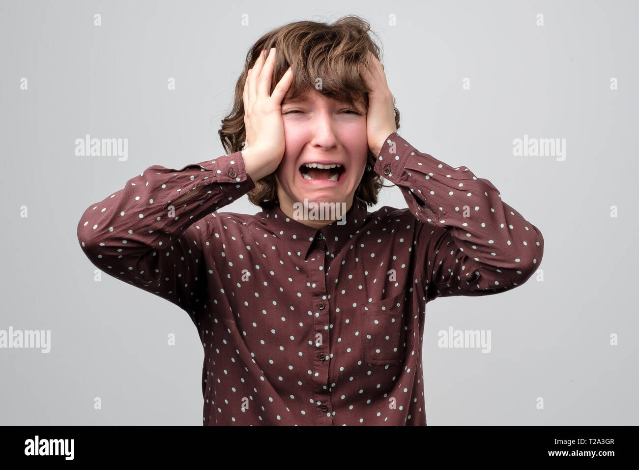 Curly young woman crying desperate overacting. Sadness and sorrow ...