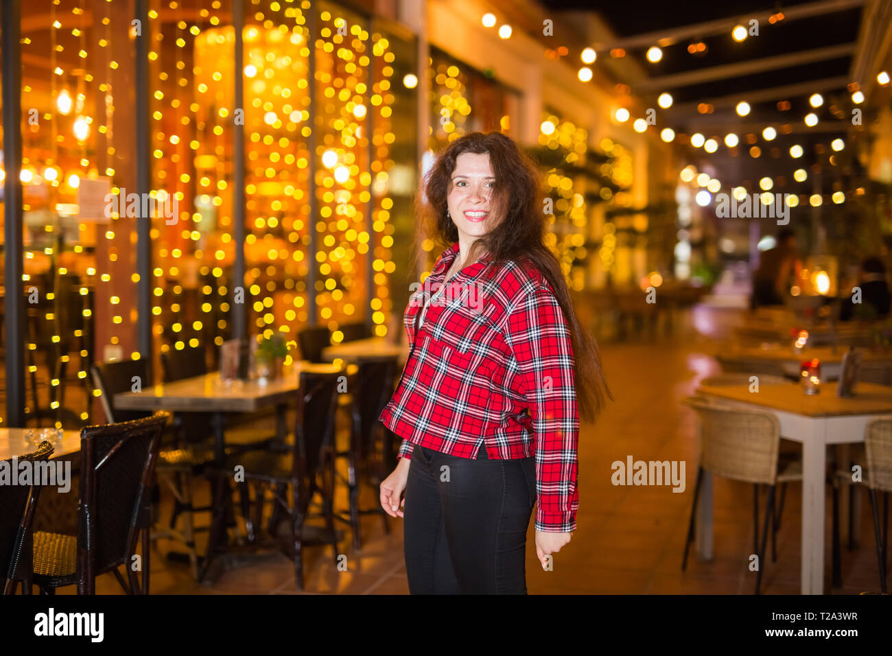 Nightlife, party and lifestyle concept - Girl walking in night city ...