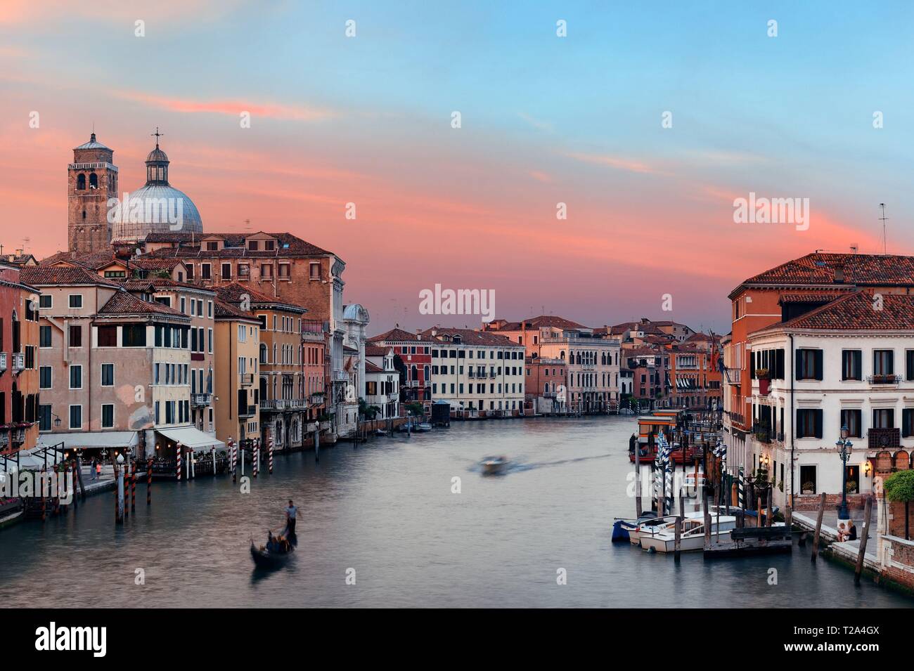 Venice grand canal sunset view with Gondola and historical buildings ...