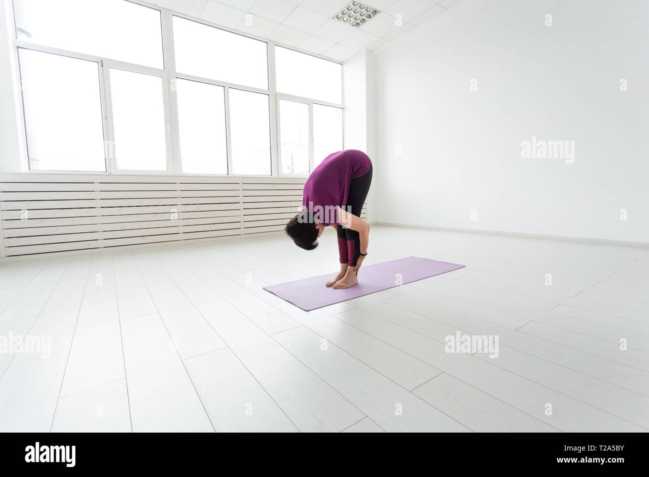 People, sport and healthcare concept - Side view of a woman doing ...