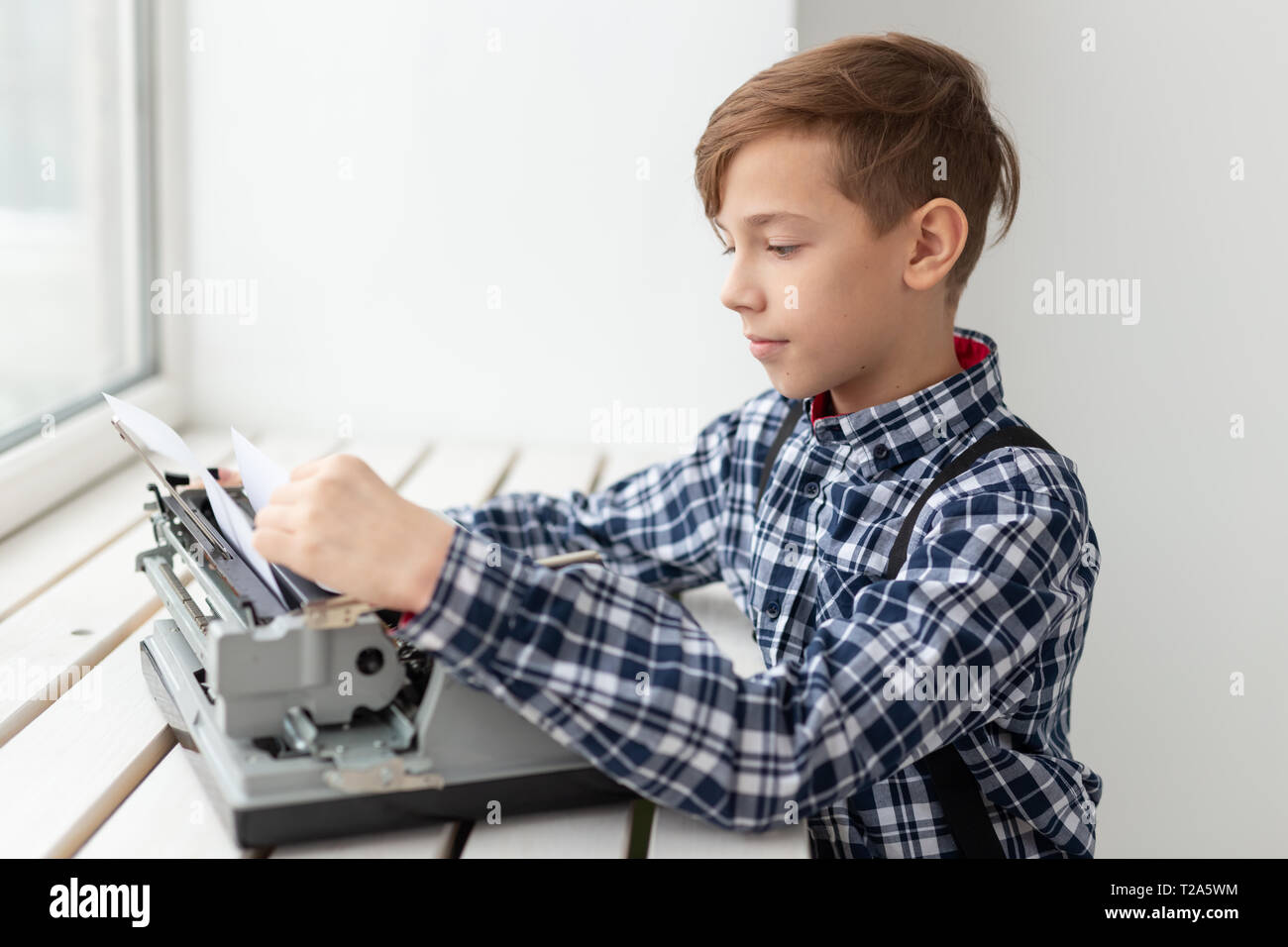 World day of the writer concept - Boy changes the paper in the ...