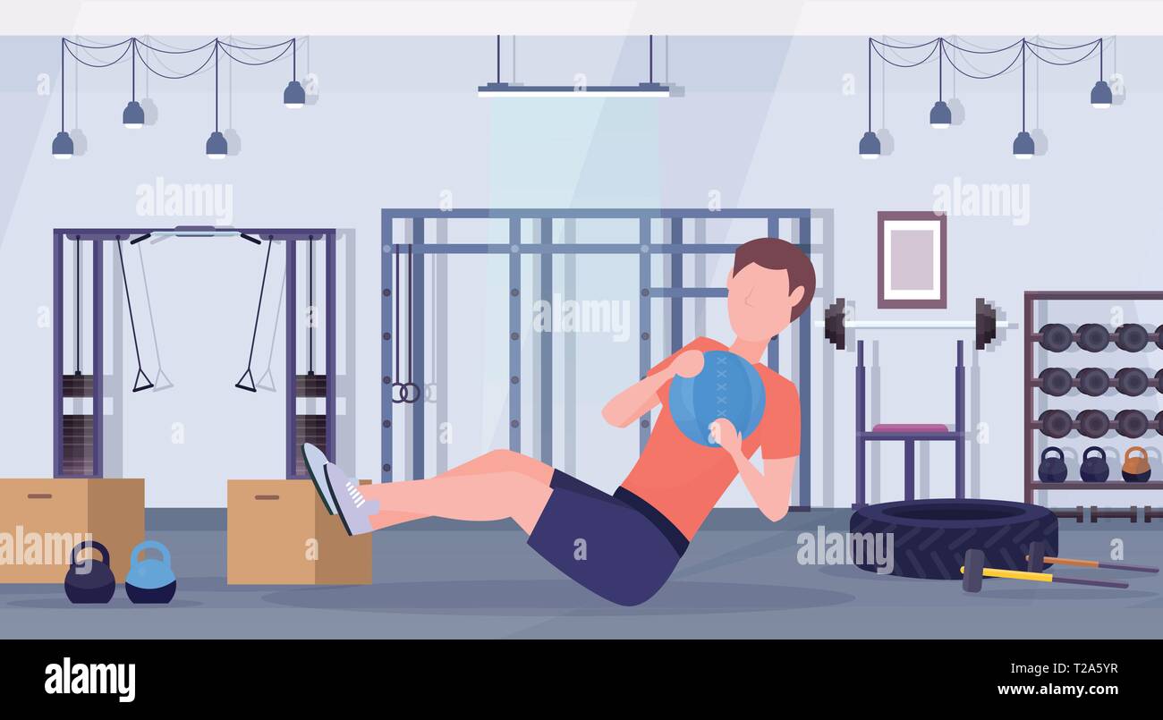 sporty man doing sit-ups exercises with medicine leather ball guy ...