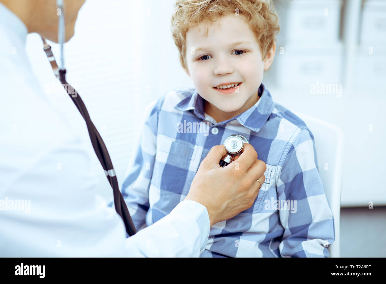 Doctor and patient child. Physician examining little boy. Regular ...