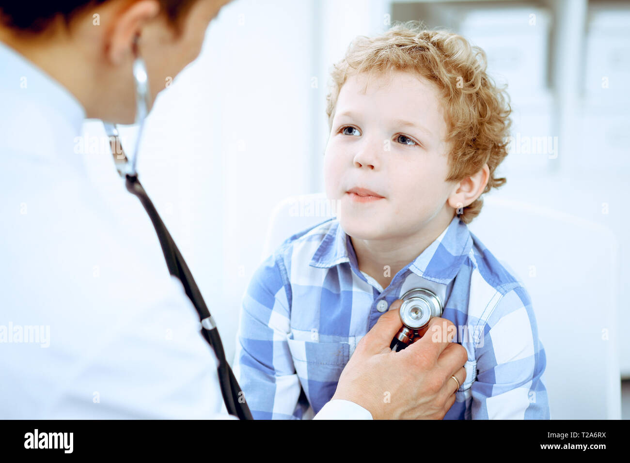 Doctor and patient child. Physician examining little boy. Regular ...