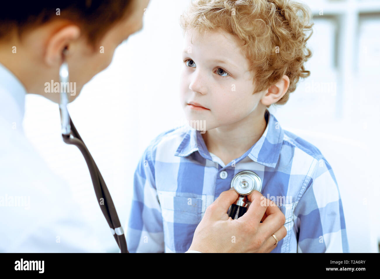 Doctor and patient child. Physician examining little boy. Regular ...