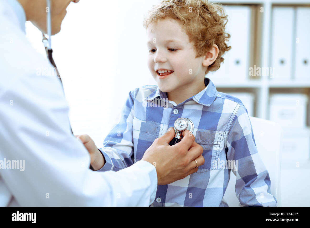 Doctor and patient child. Physician examining little boy. Regular ...