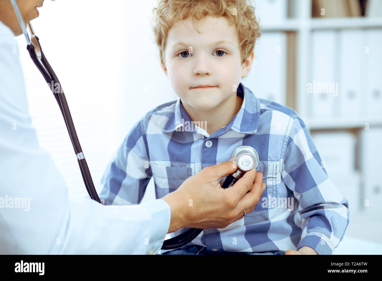 Doctor and patient child. Physician examining little boy. Regular ...