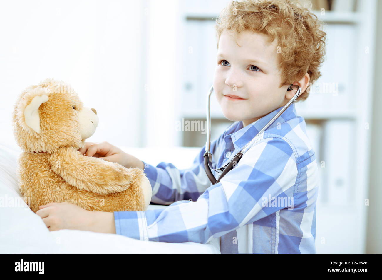 Doctor and patient child. Physician examining little boy. Regular ...