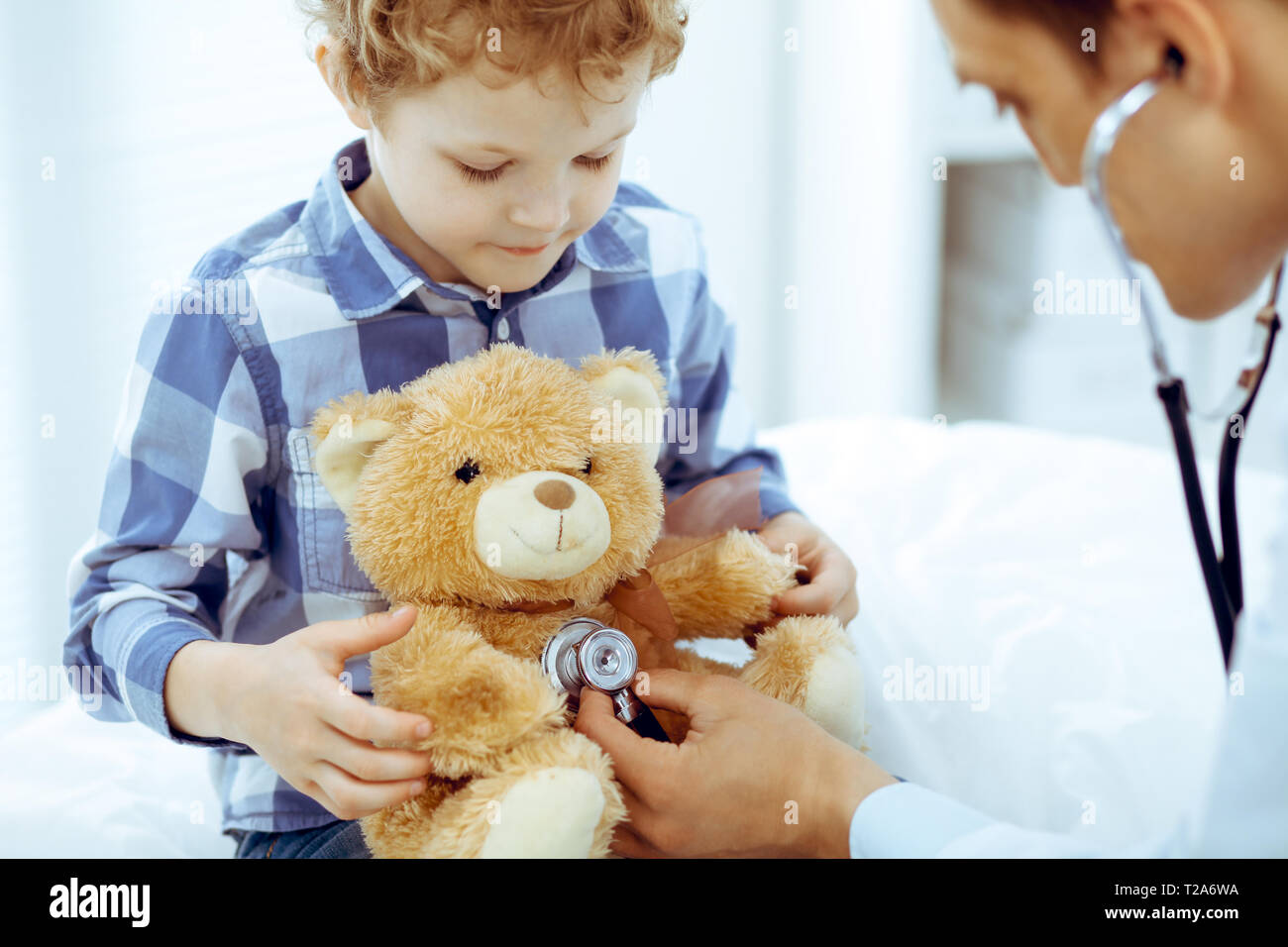 Doctor and patient child. Physician examining little boy. Regular ...