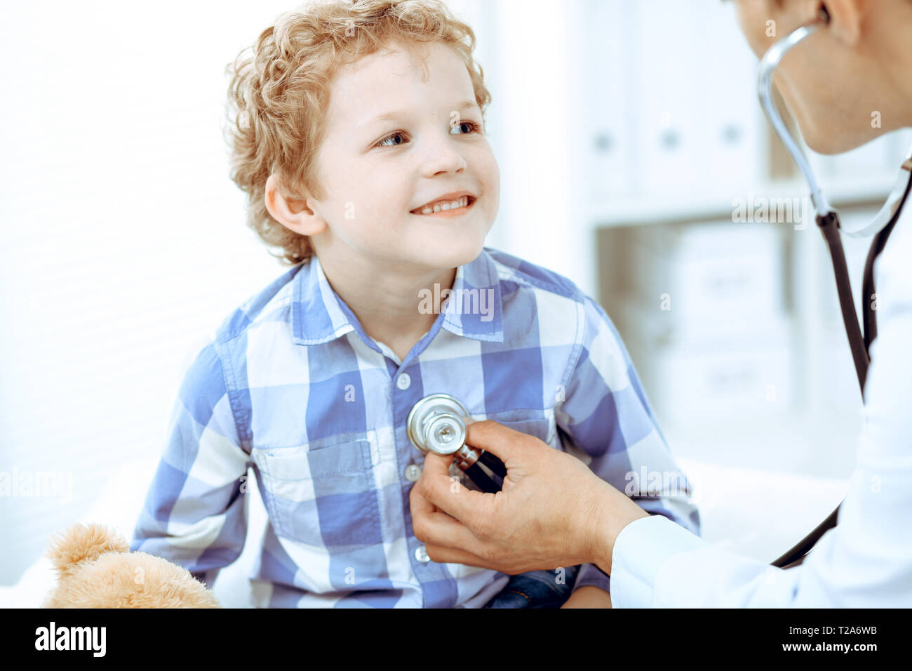 Doctor and patient child. Physician examining little boy. Regular ...