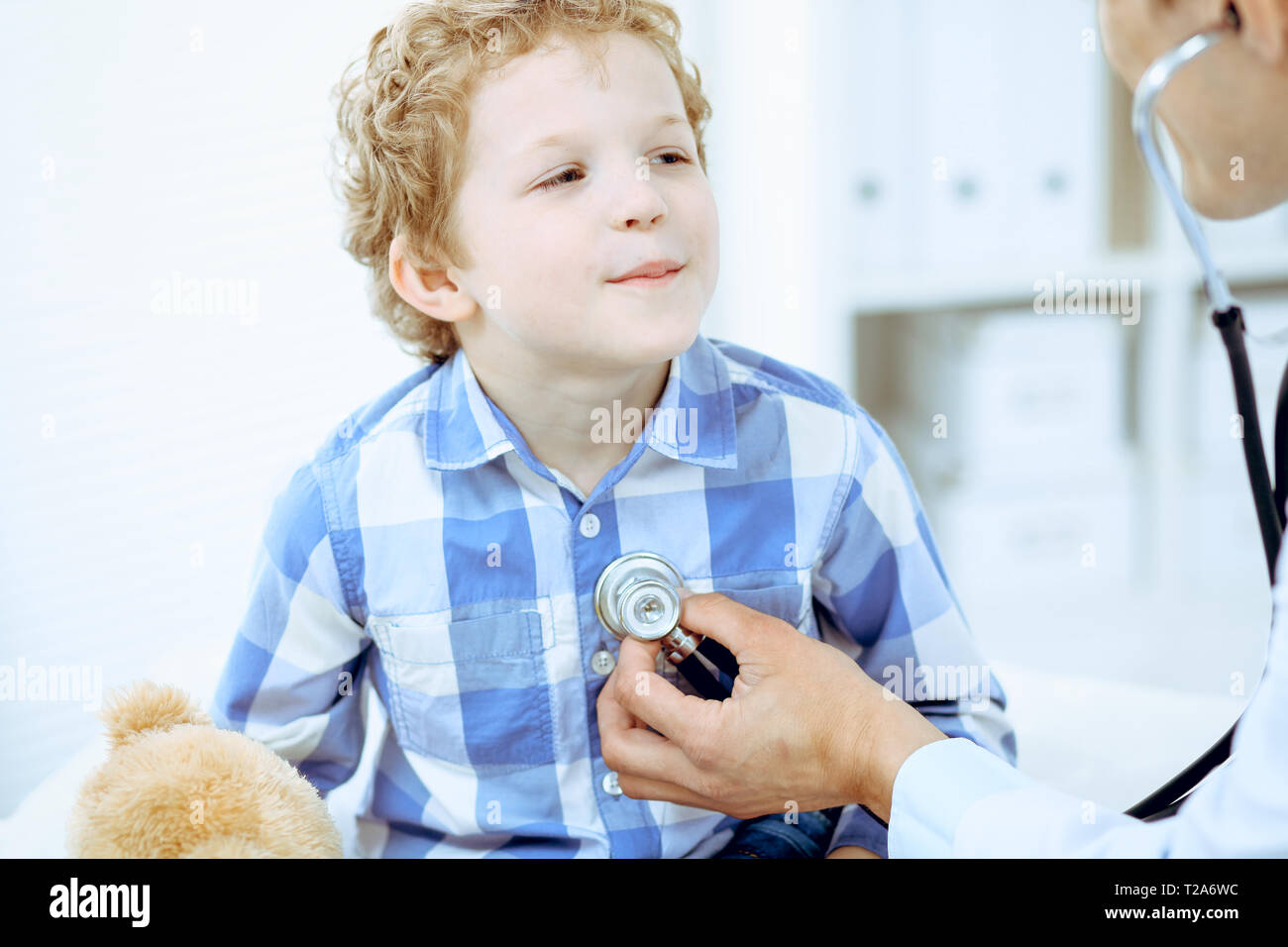Doctor and patient child. Physician examining little boy. Regular ...