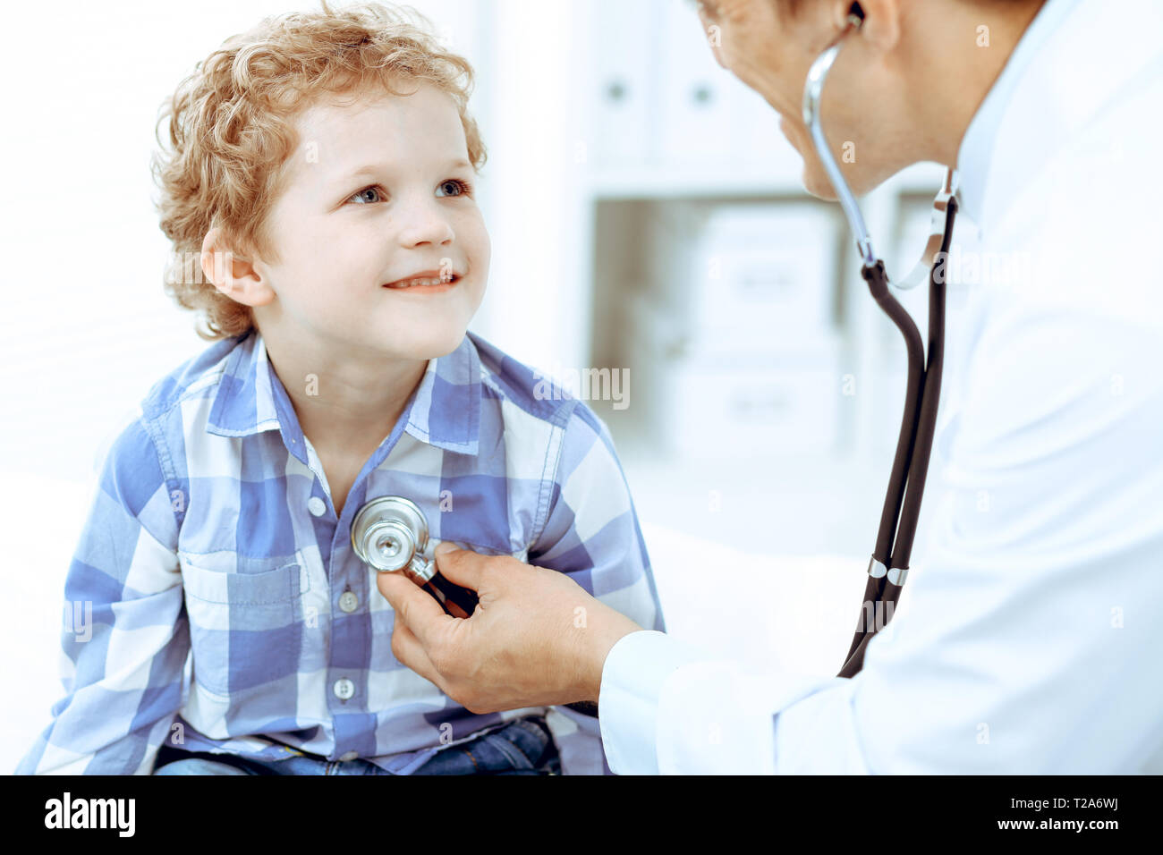 Doctor and patient child. Physician examining little boy. Regular ...