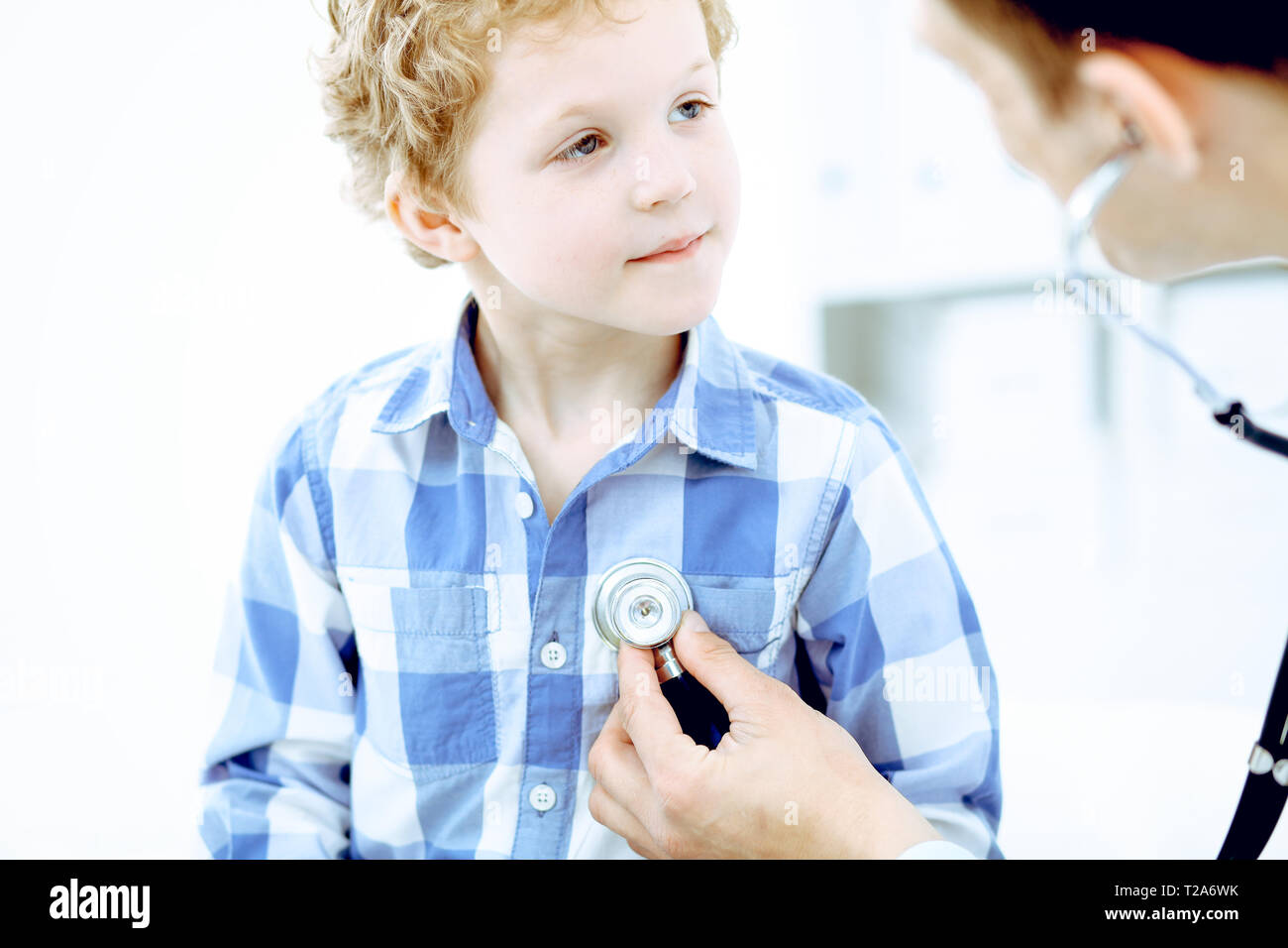 Doctor and patient child. Physician examining little boy. Regular ...