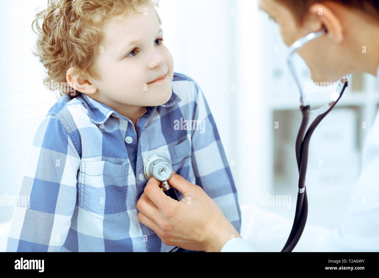 Doctor and patient child. Physician examining little boy. Regular ...
