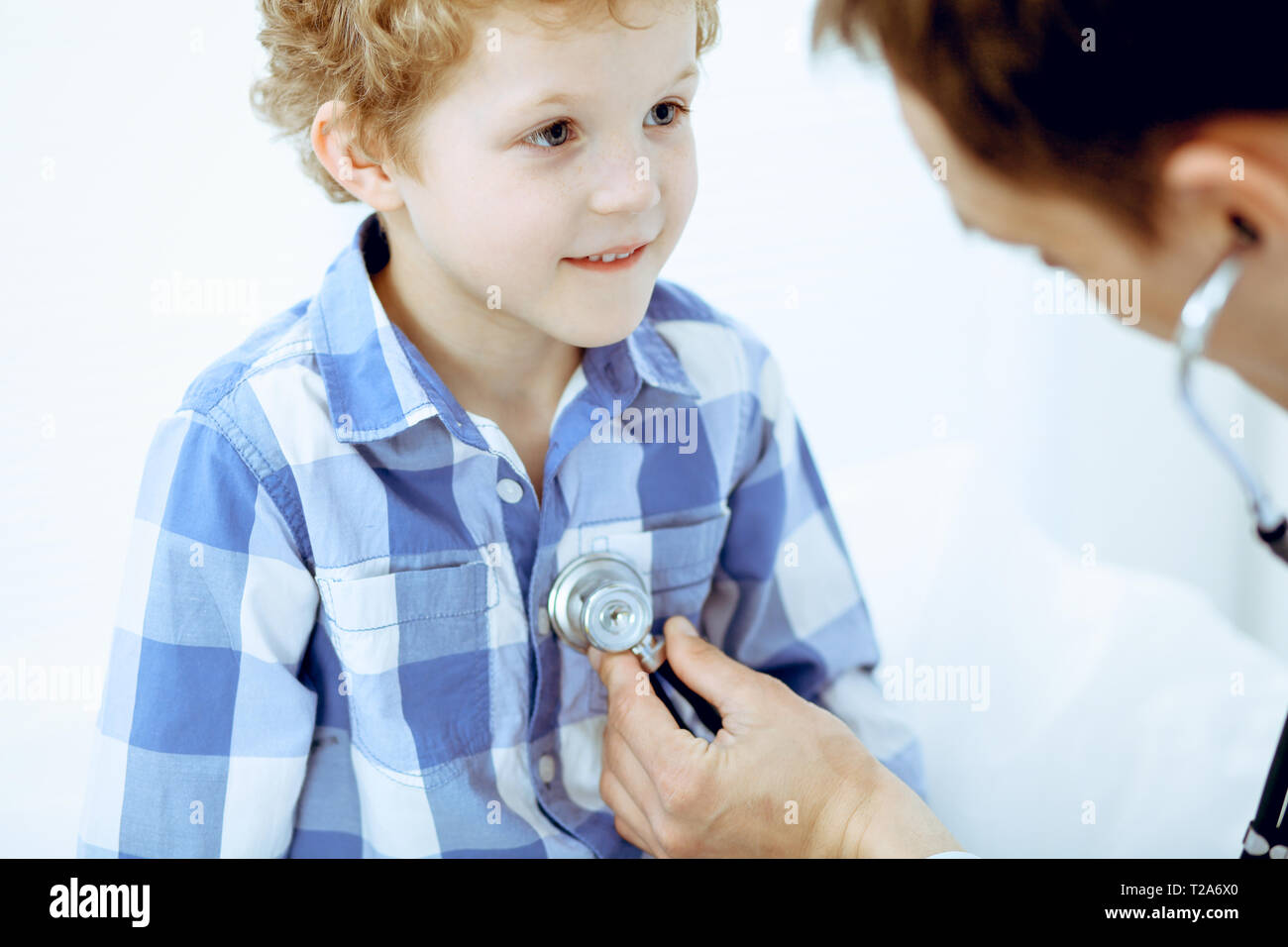 Doctor and patient child. Physician examining little boy. Regular ...
