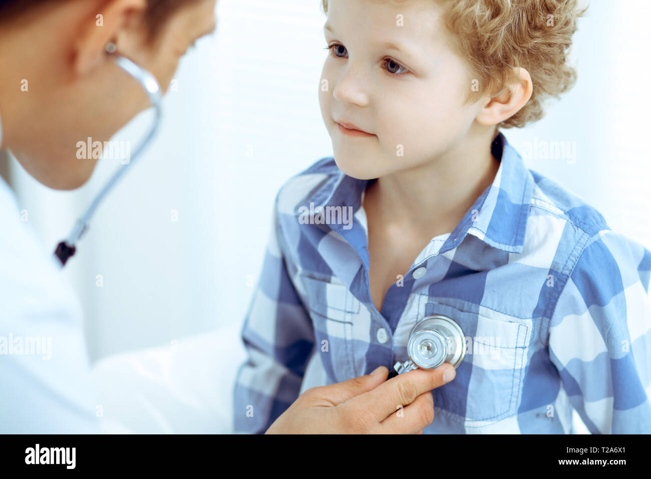 Doctor and patient child. Physician examining little boy. Regular ...