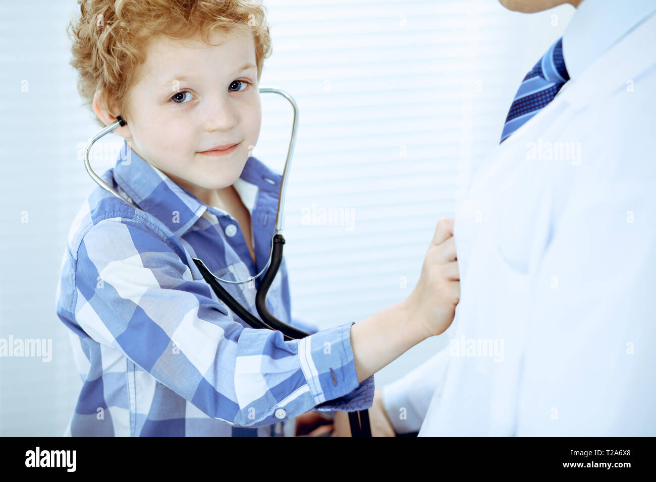 Doctor and patient child. Physician examining little boy. Regular ...