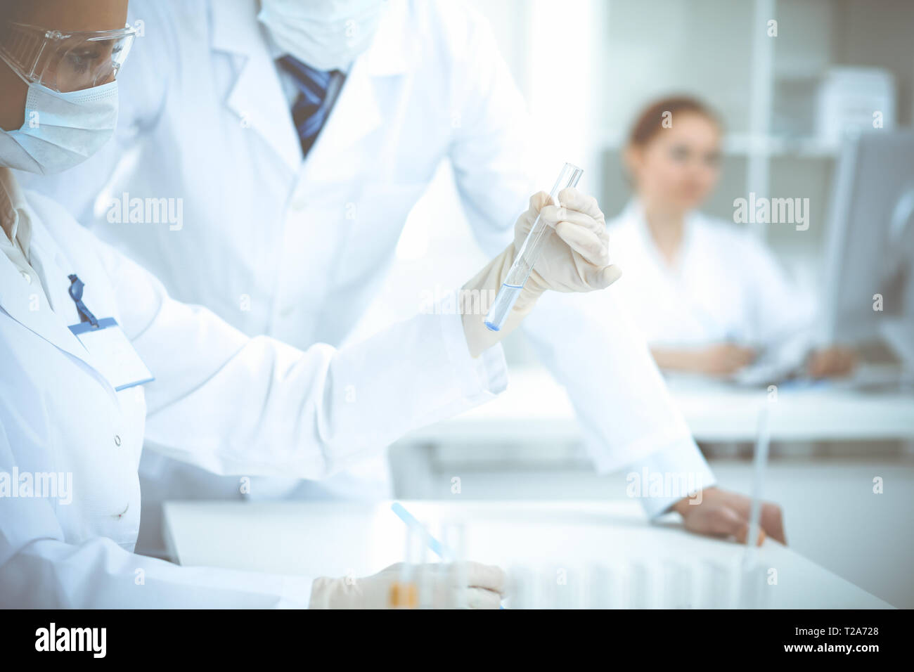 Scientific research team with clear solution in laboratory Stock Photo ...