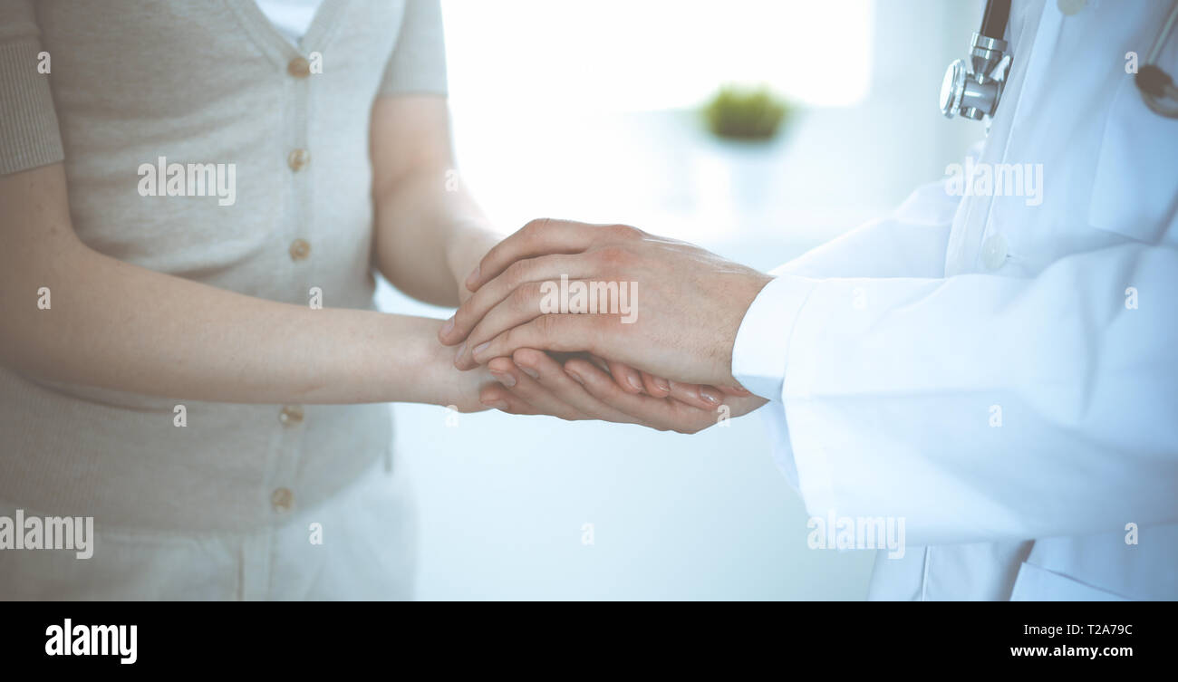 Hand of doctor reassuring her female patient. Medicine and health care ...