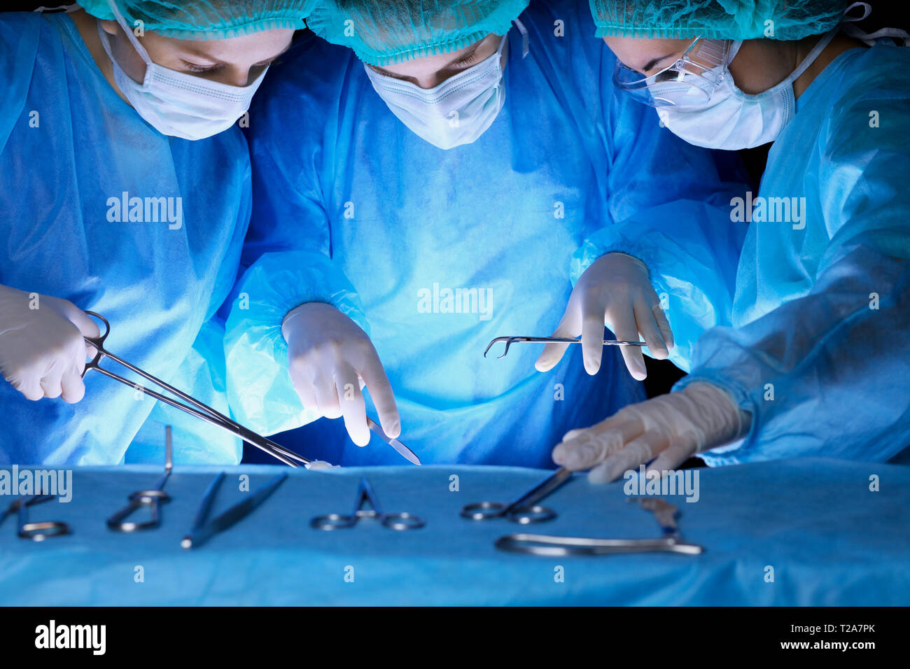 Group of surgeons in masks performing operation. Medicine, surgery and ...