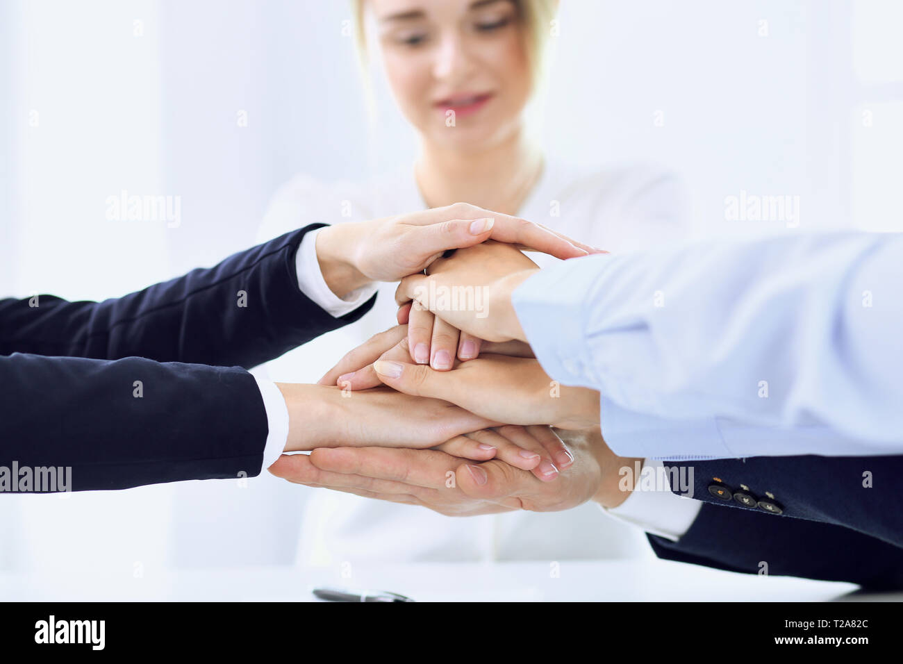 Business people happy showing teamwork and giving five showing unity ...