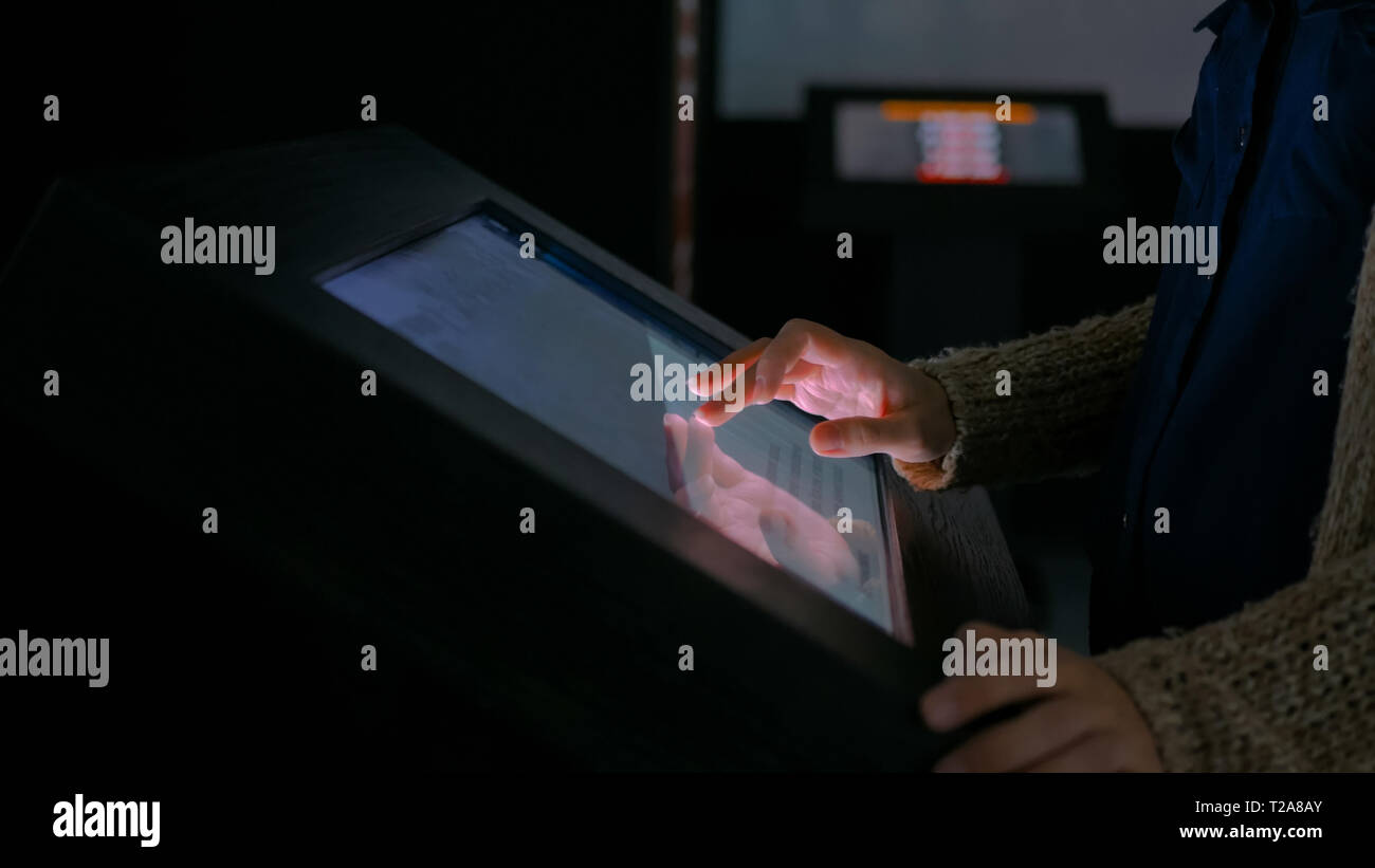 Woman using interactive touchscreen display Stock Photo - Alamy