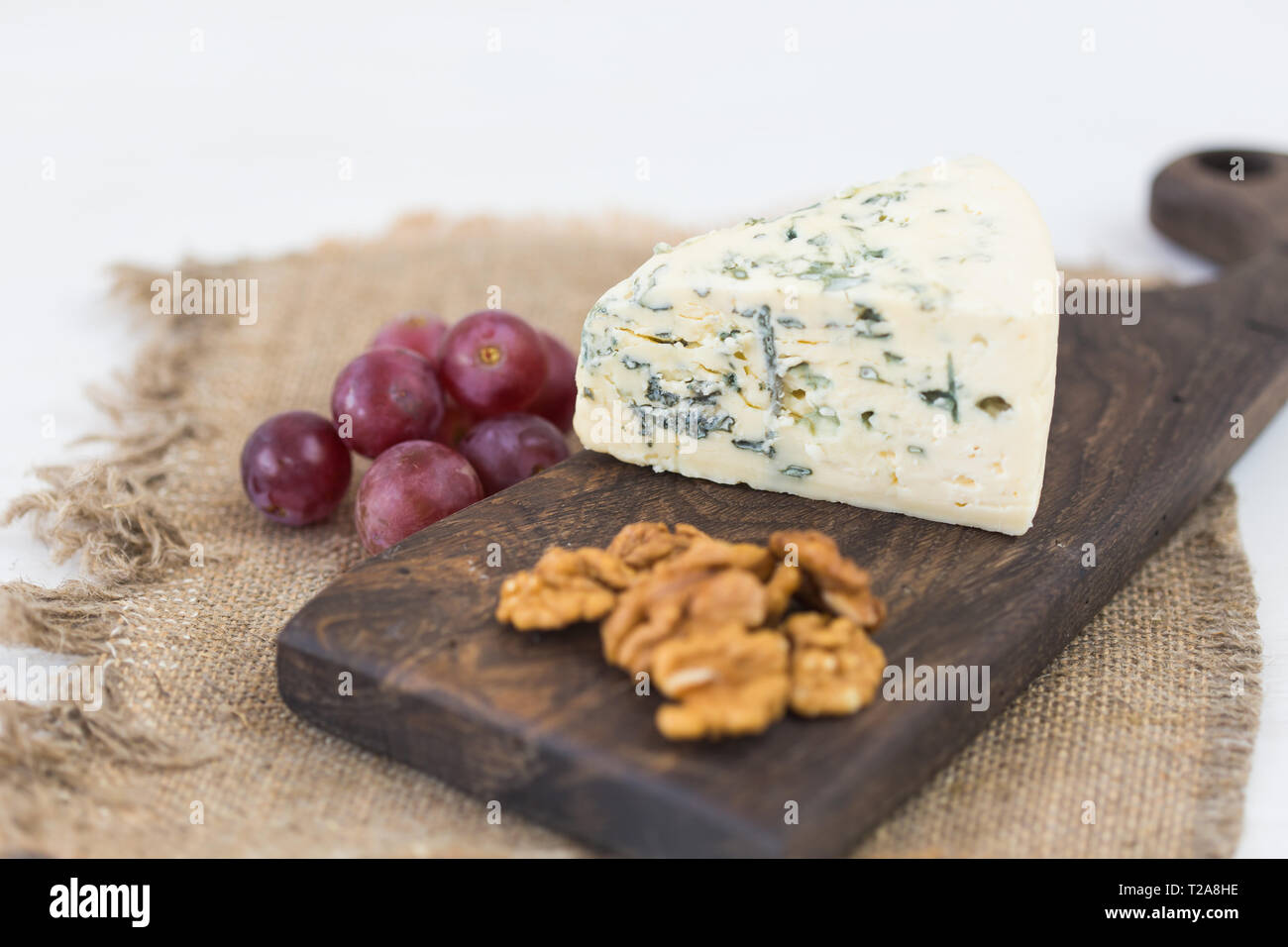 Blue cheese or brie with grapes and nuts Stock Photo - Alamy