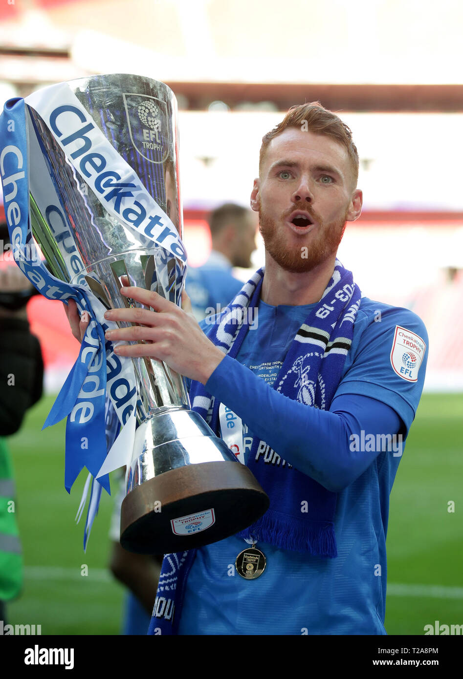 Portsmouth's Tom Naylor lifts the trophy during the Checkatrade Trophy ...