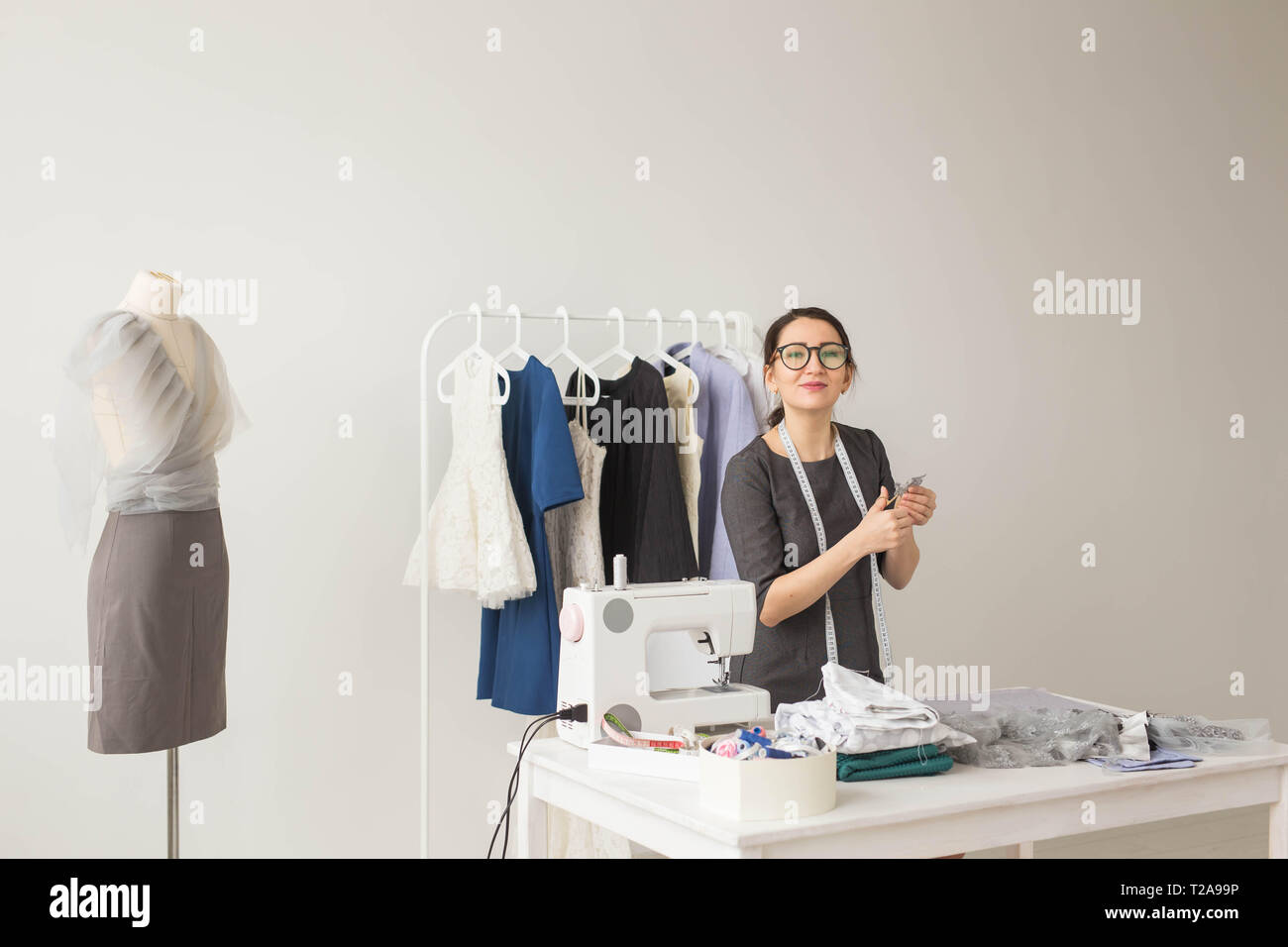 Dressmaker, fashion designer and tailor concept - Young woman designer ...