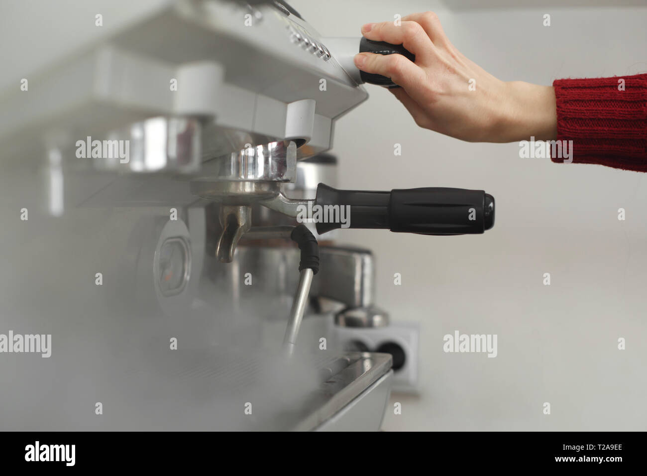 Barista drops off preasure steam from coffee machine Stock Photo - Alamy
