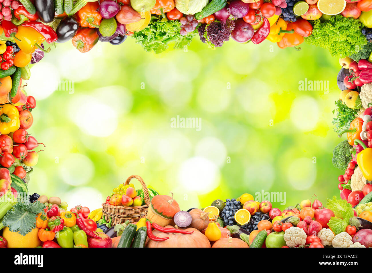 Frame of fruits and vegetables on abstract blurry plant background ...