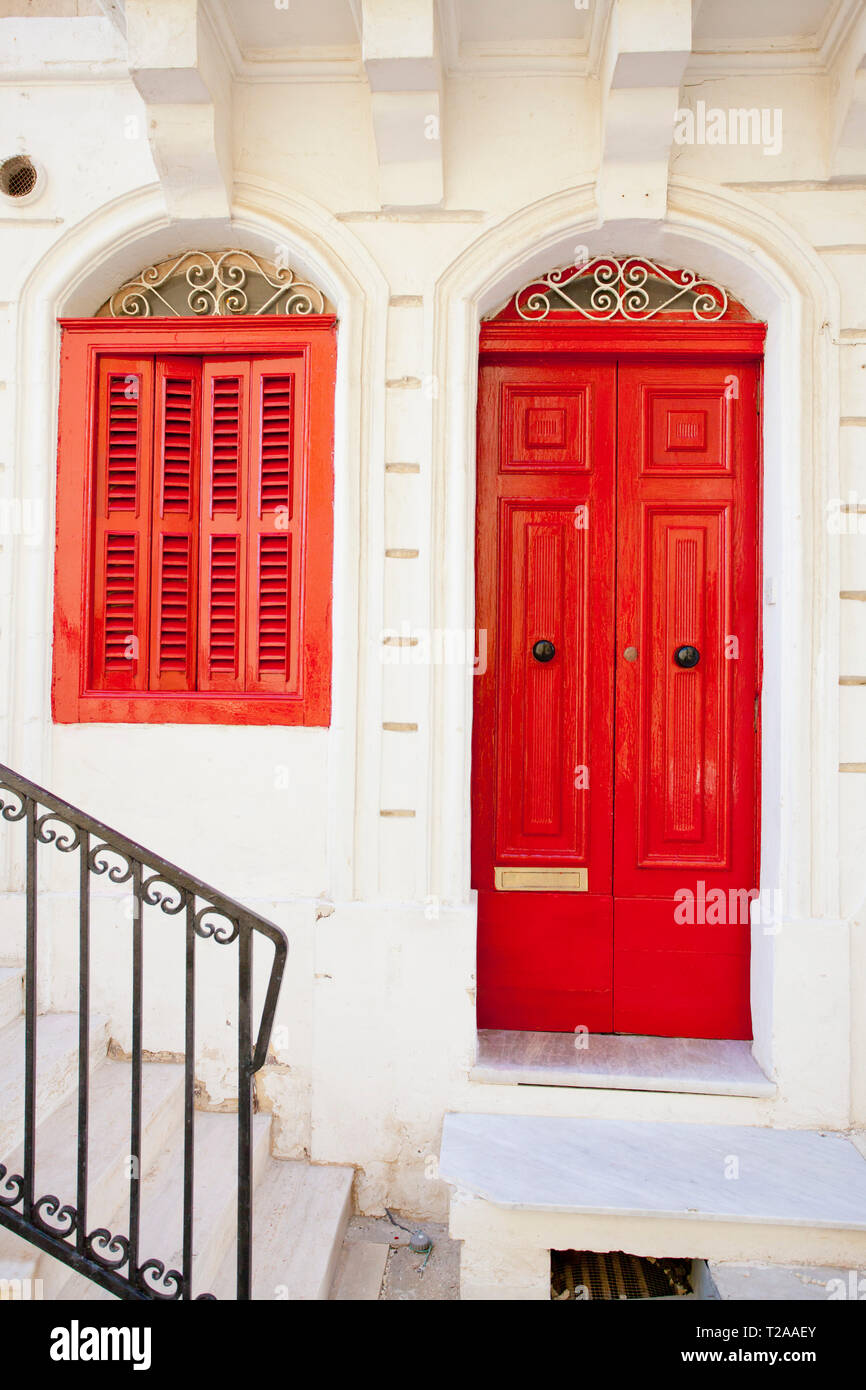 Red shuttered window and red door Stock Photo - Alamy