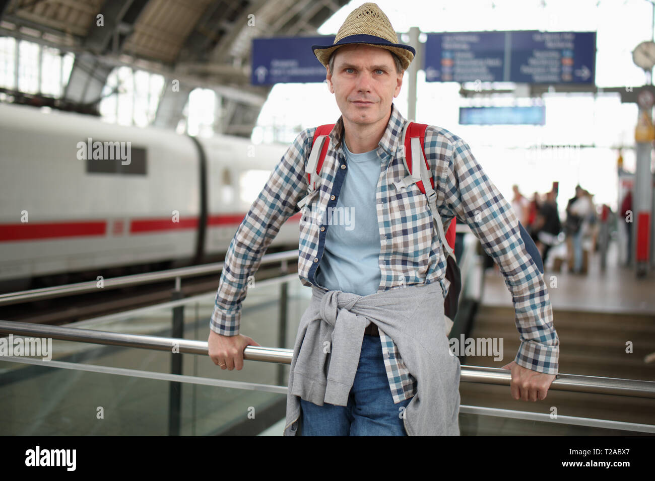 Mature traveler with backpack on the railroad station in Berlin ...