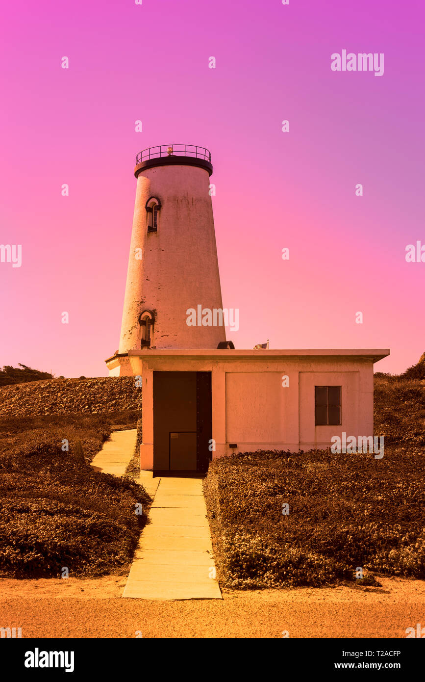 Sunset on lighthouse setting on hilltop Stock Photo - Alamy