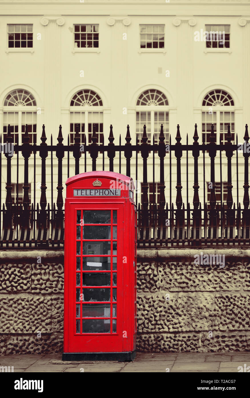 Red telephone box in street with historical architecture in London ...