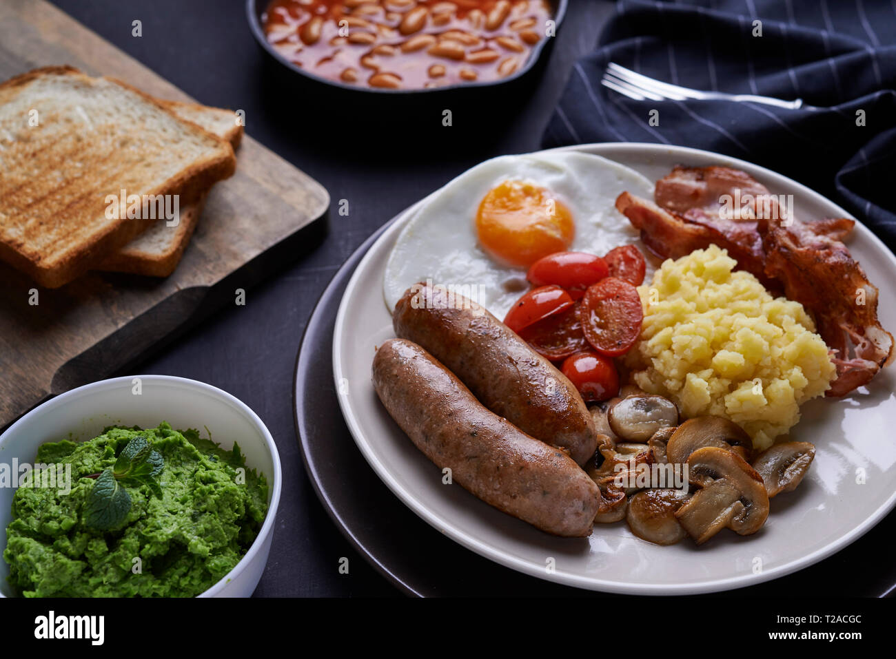 full english breakfast with eggs, sausages, potato, beans, bacon ...