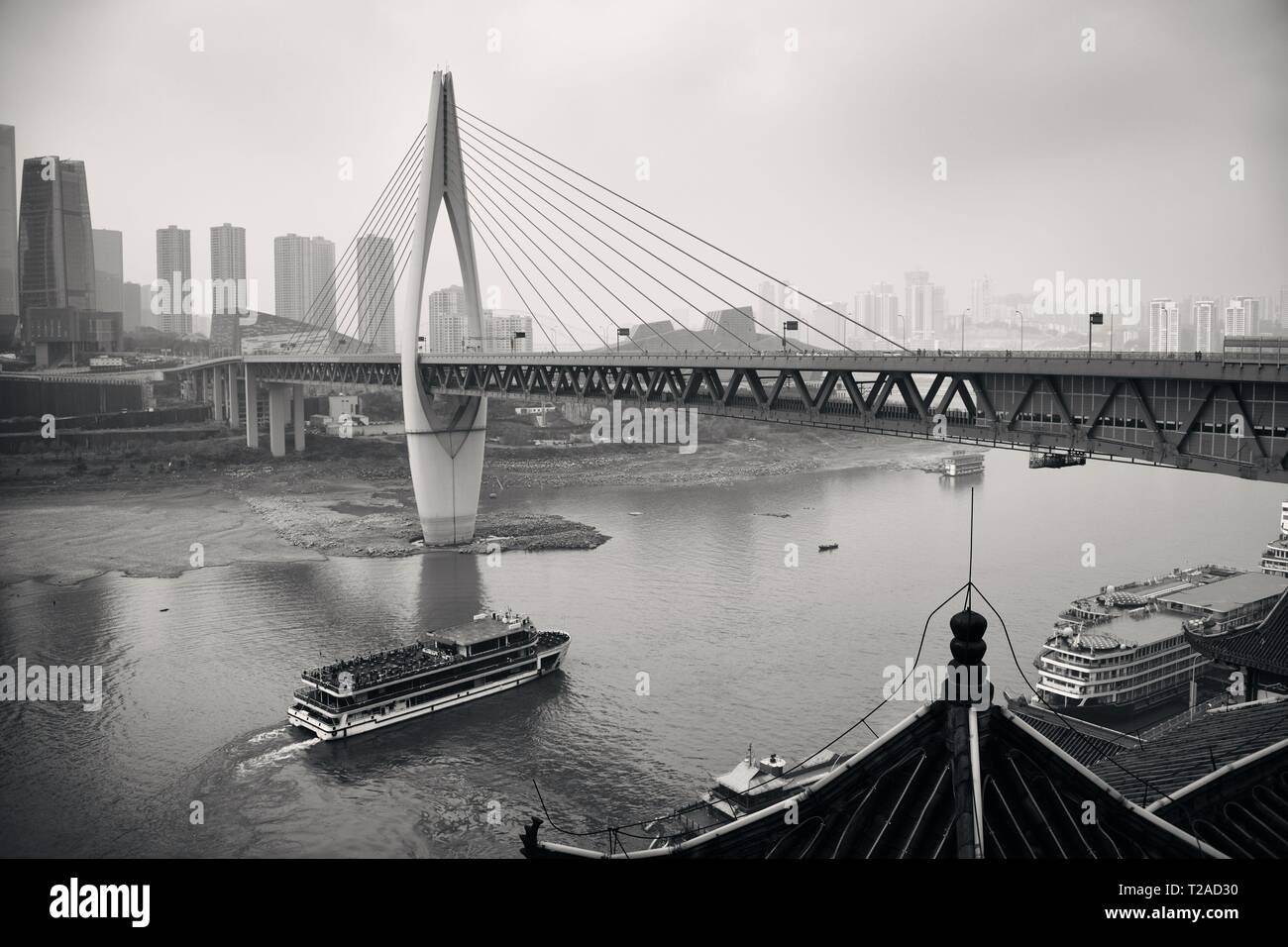 Boat pass below bridge with city urban architecture in Chongqing, China ...