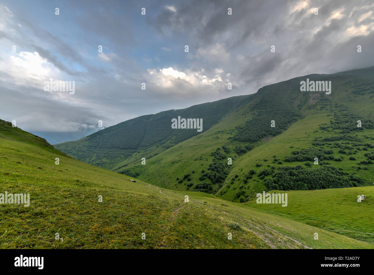Hilly landscape near the village of Gergeti in Georgia, under Mount ...