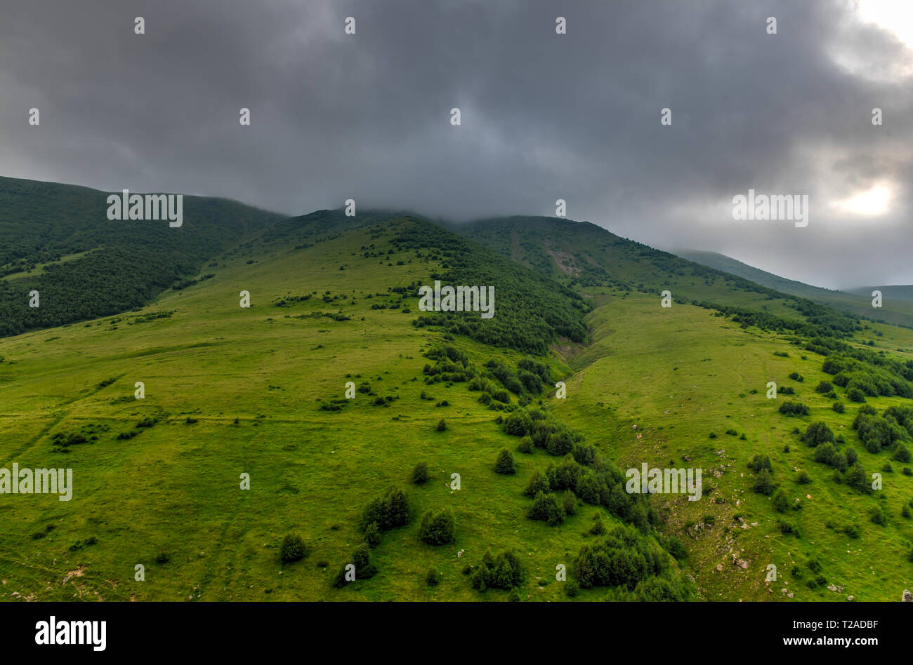 Hilly landscape near the village of Gergeti in Georgia, under Mount ...