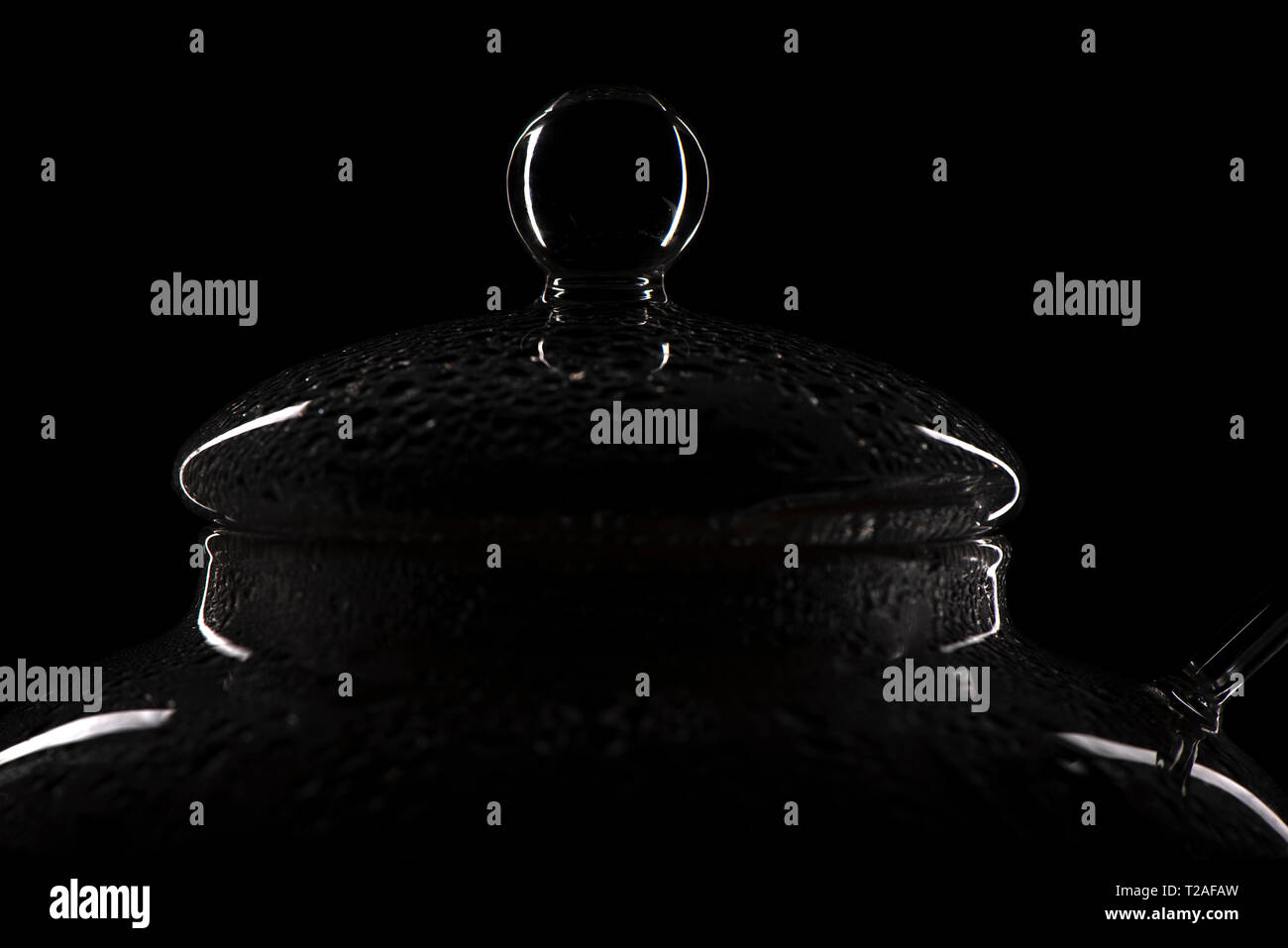 the lid of the kettle with boiling water on the walls, a drop of steam ...