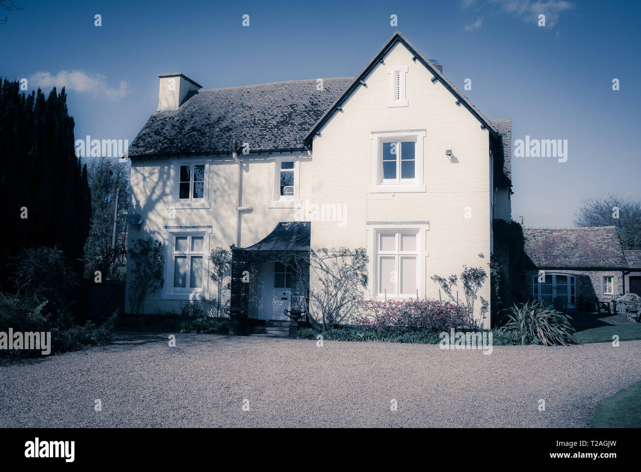 White traditional British country house with big gravel yard at the ...