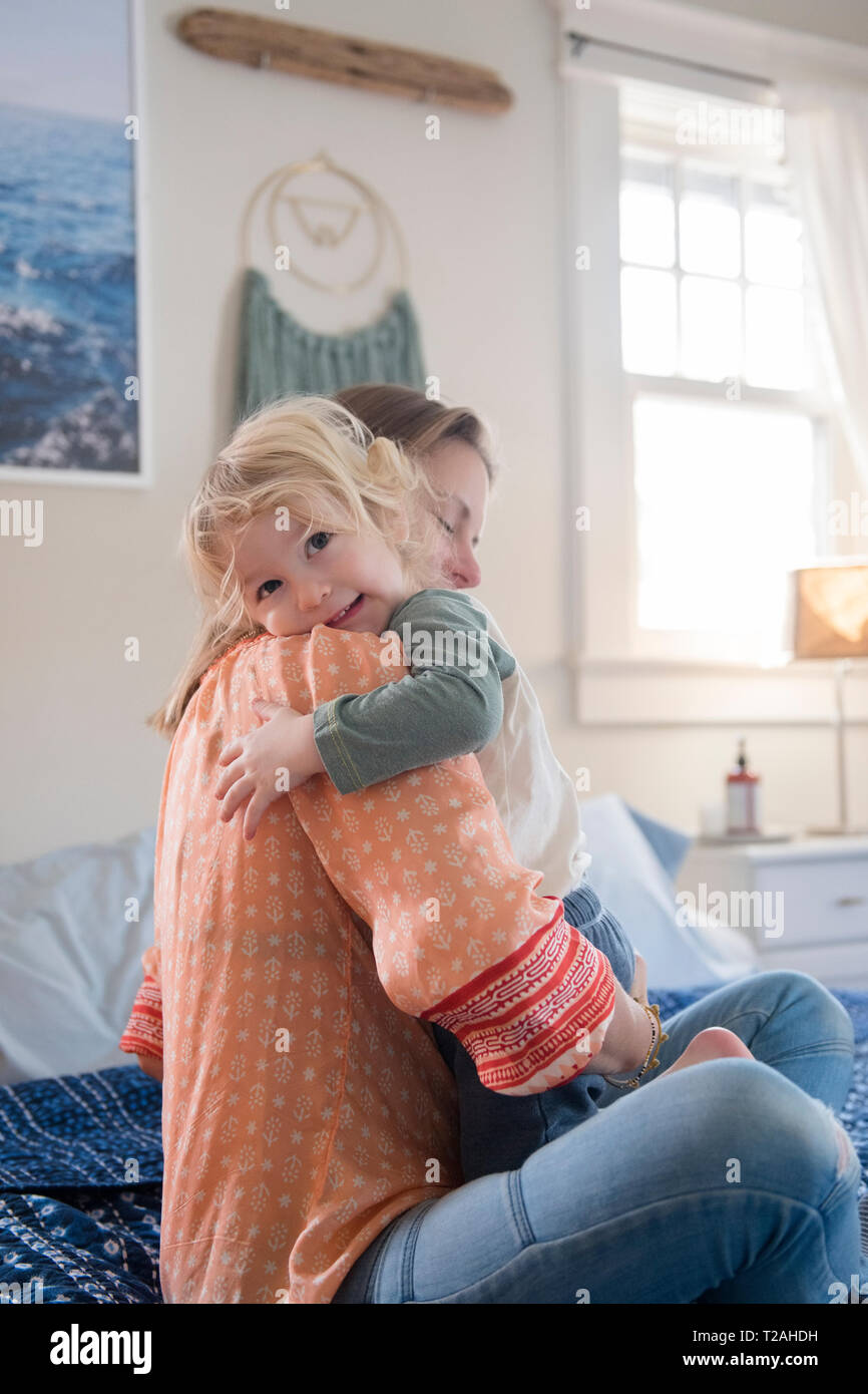 Woman hugging her son Stock Photo - Alamy