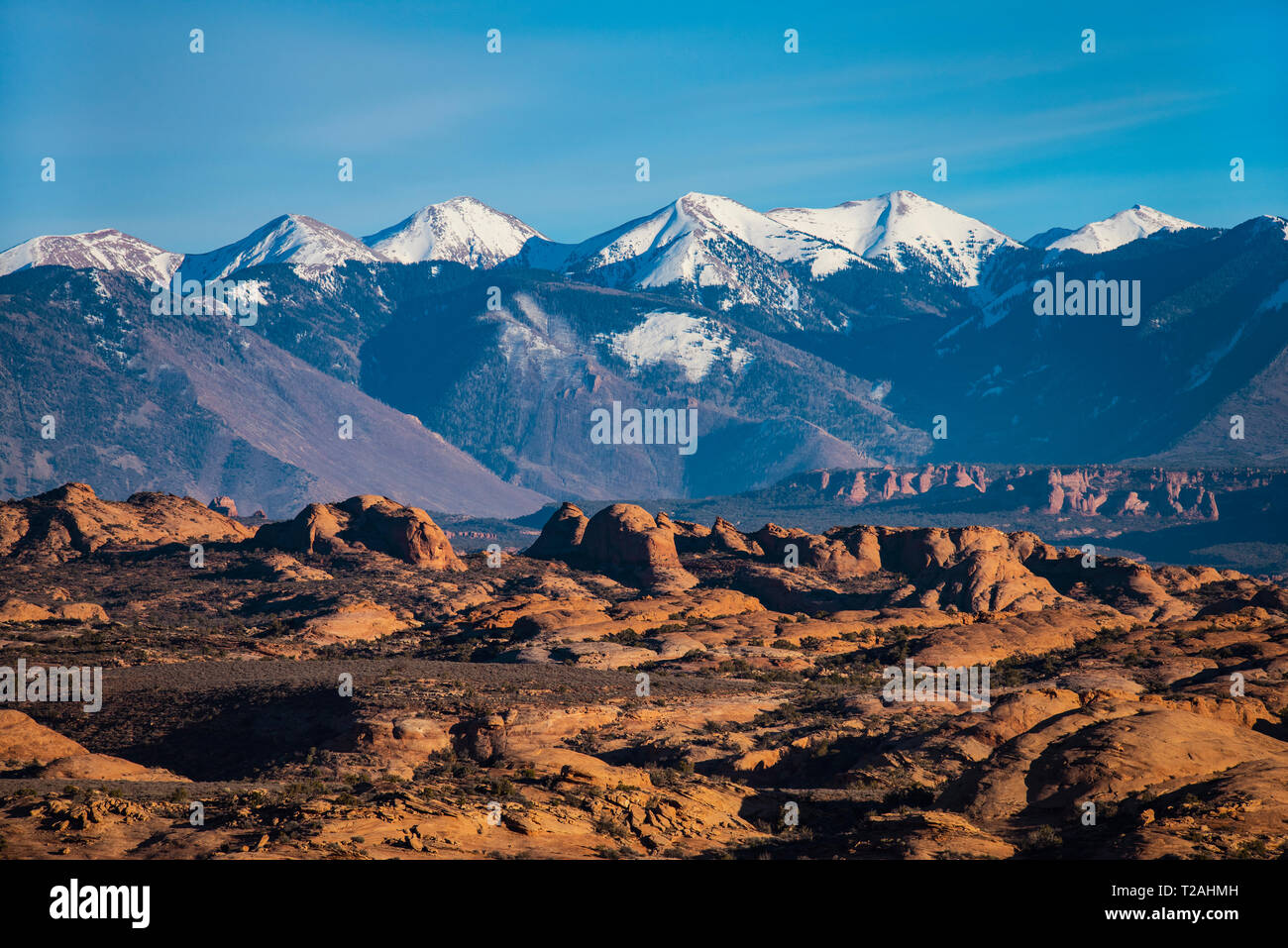 Snowcapped La Sal Mountains and sand dunes in Arches National Park ...