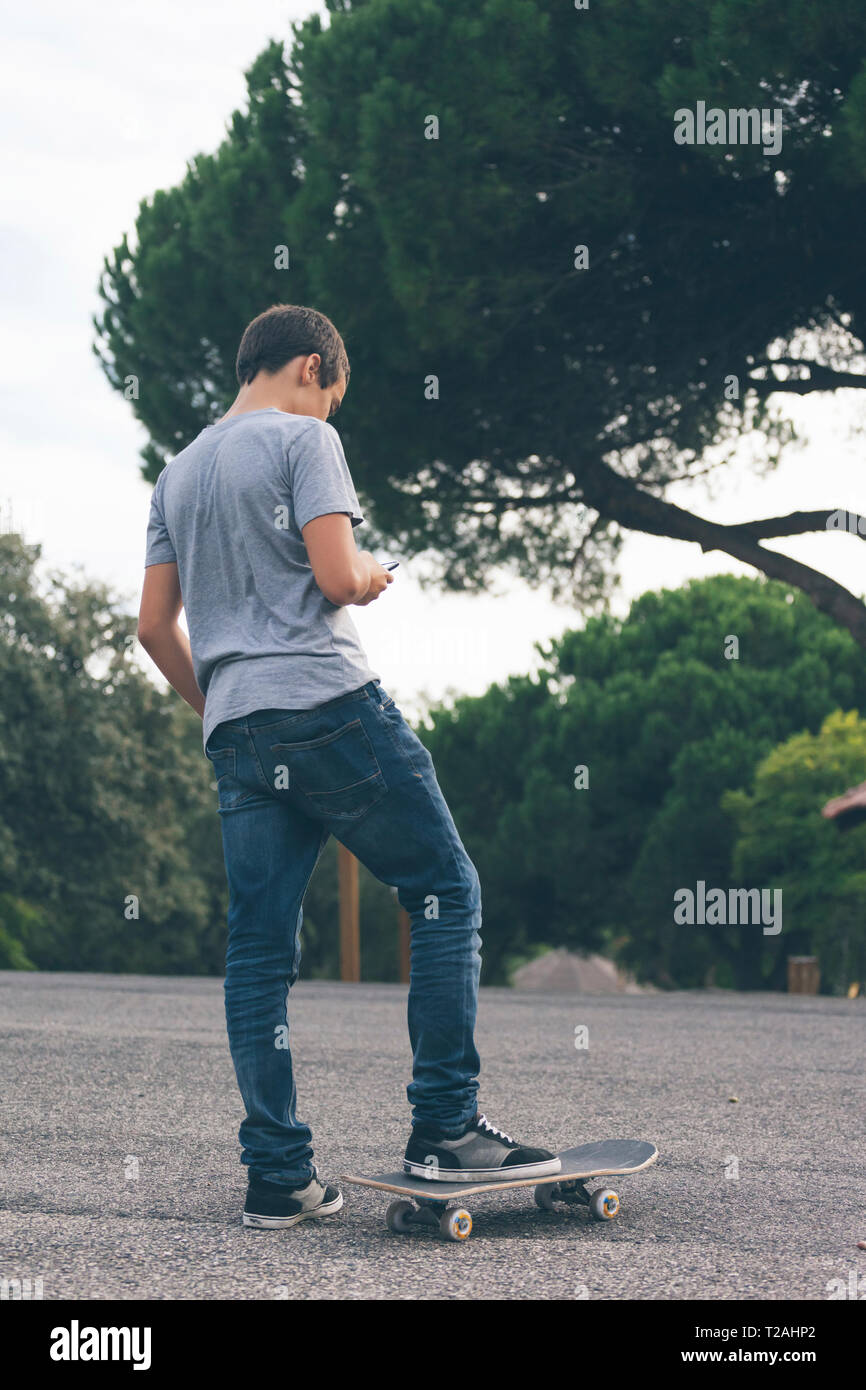 Young adult man holding skateboard hi-res stock photography and images ...